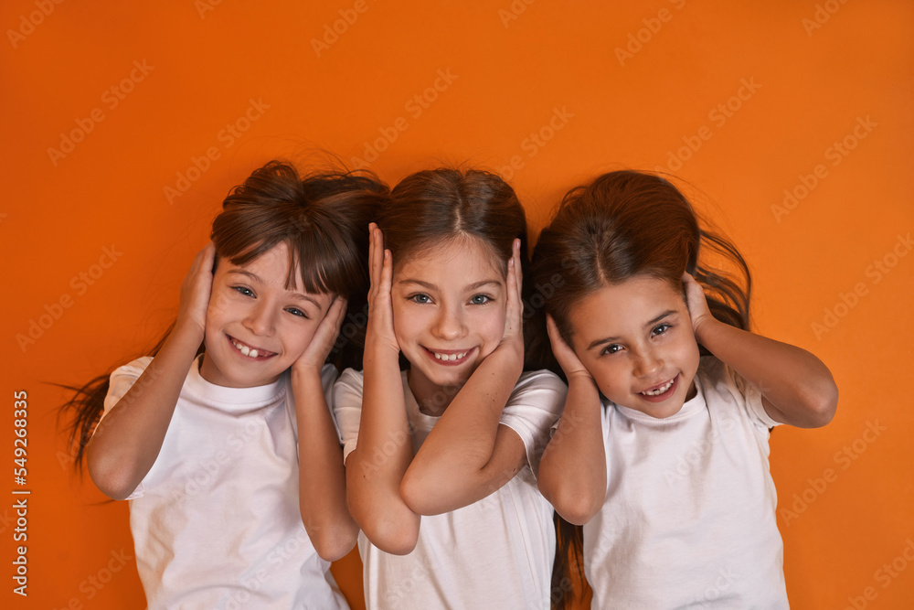 Cropped top view of caucasian girls covering ears Stock Photo | Adobe Stock