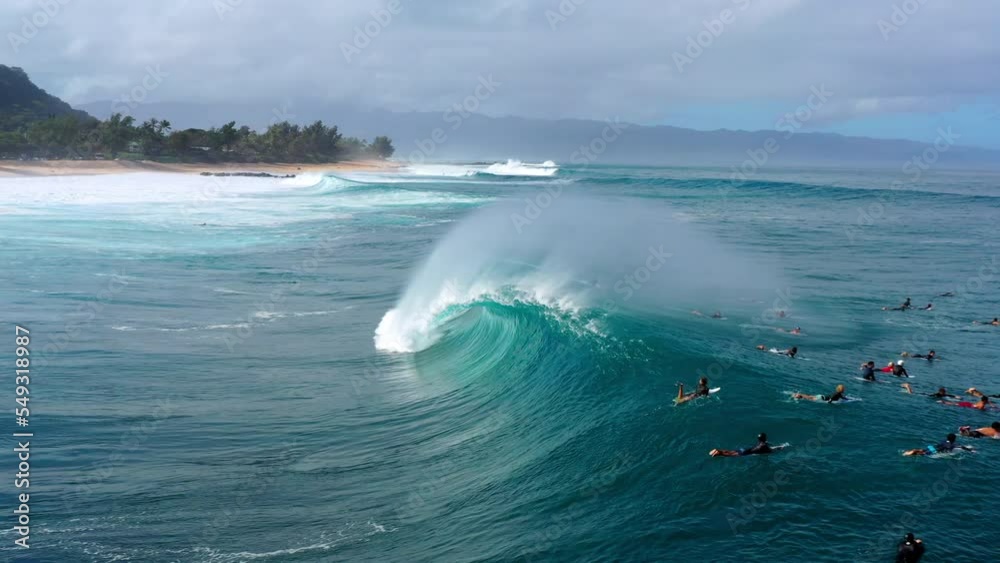 Aerial Panning Shot Of Tourists Surfboarding On Wavy Ocean At Beach ...