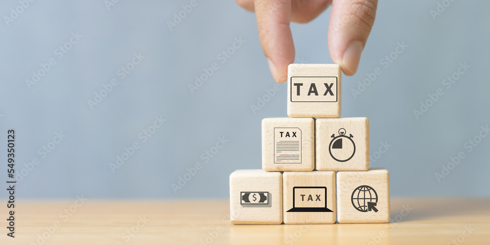 Place tax icon in wooden cube for income tax return and submit tax for ...