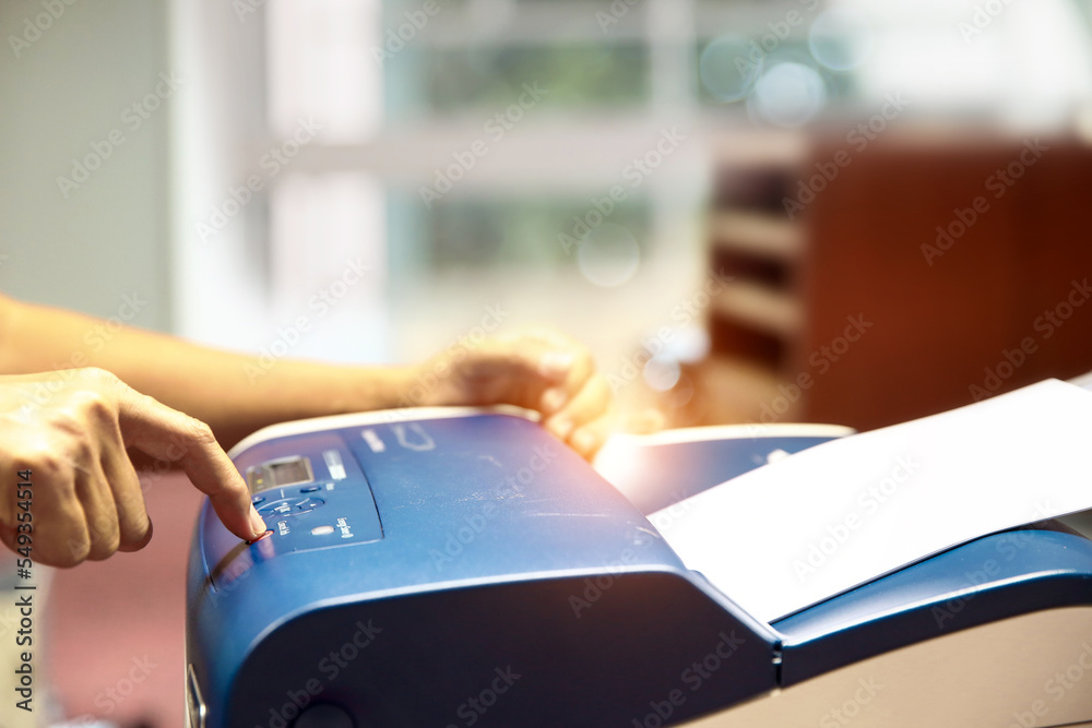 Technician hand press button and load paper in tray to using ...