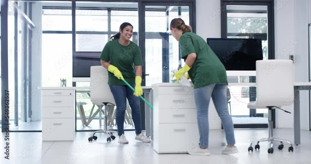 Happy women cleaning an office together, safety and hygiene in the ...