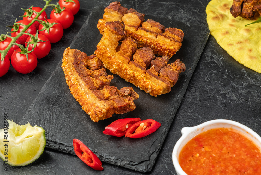 Grilled pork belly with crispy skin. chicharones, a traditional snack ...