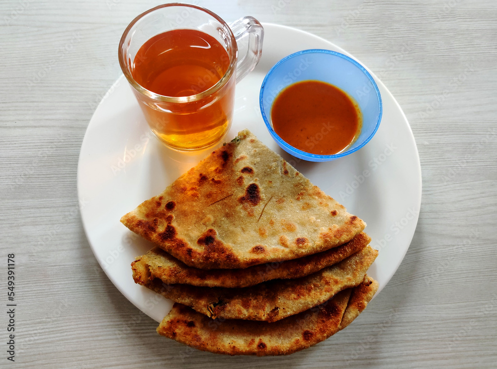 Aloo paratha with black tea,Aloo paratha is a paratha stuffed with ...