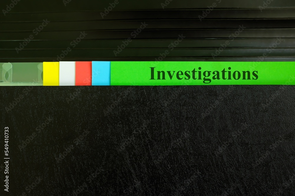 Investigations file record in black binder folder. Crime, legal and ...
