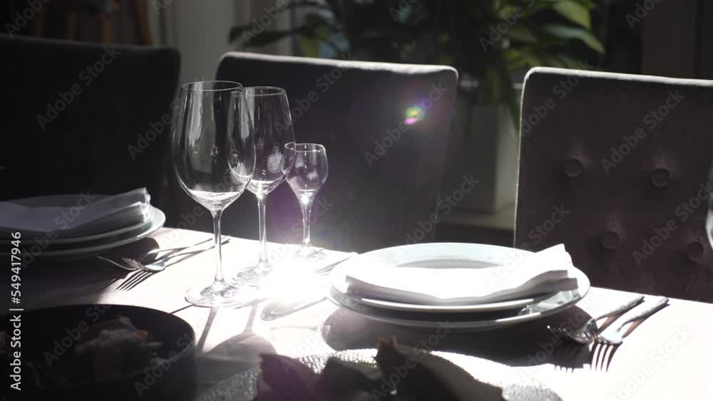 Beautifully set table with bright tableware in a restaurant. Sunlight ...