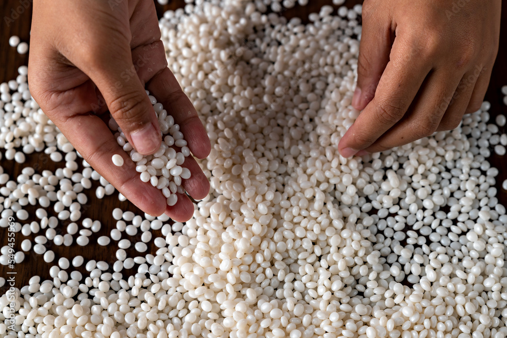 Close-up of plastic polymer granules, hand hold Polymer pellet, polymer ...