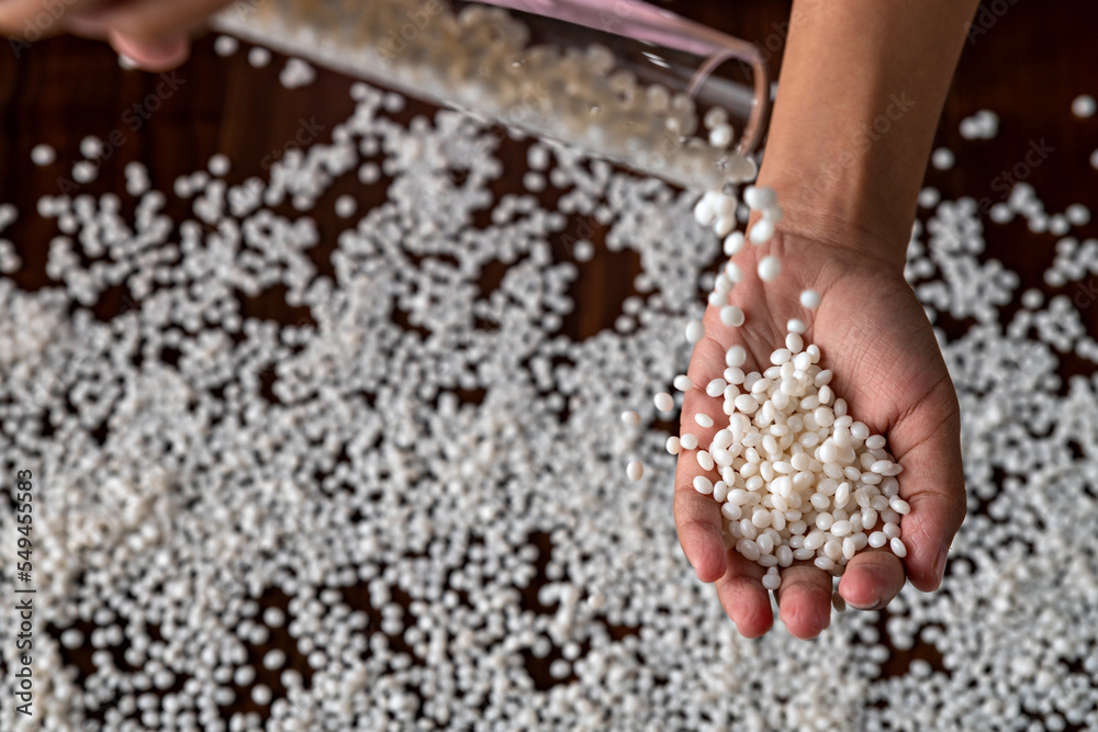 Close-up of plastic polymer granules, hand hold Polymer pellet, polymer ...
