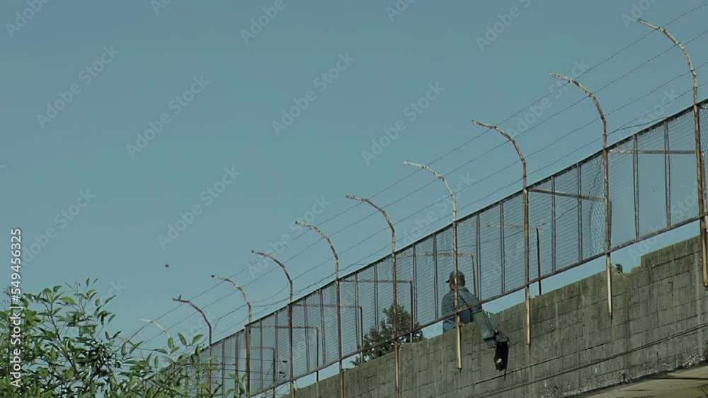 Prison Officer walking Along an Outdoor Walkway in an Old Prison in ...