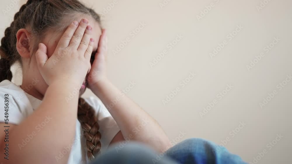 sad girl sitting in the corner crying a covered her face with her hands ...