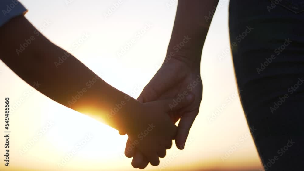 happy family. Mom lends helping hand to her daughter girl in nature in ...