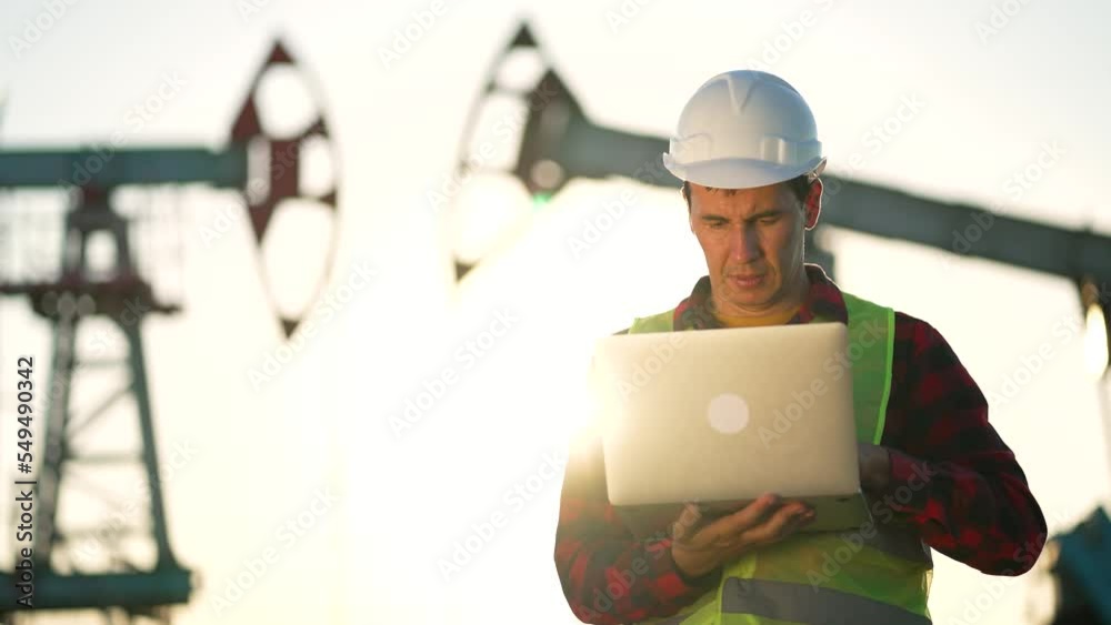 Oil pump.Engineer work with laptop and diagram.Checking operation of ...