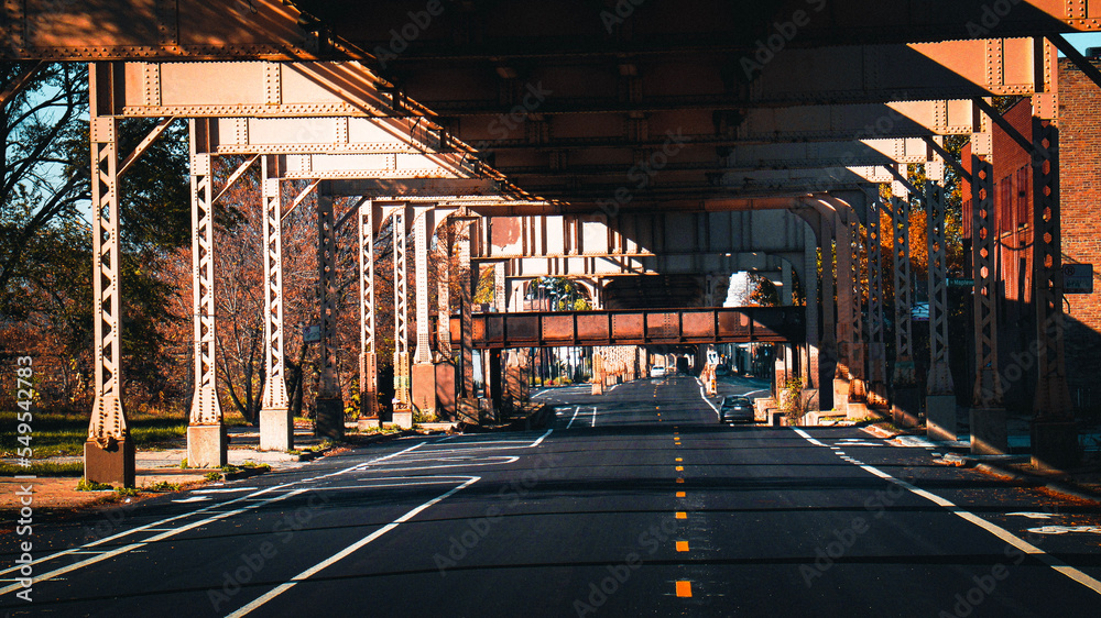 Under the elevated train tracks with light and dark contrast. Living in ...