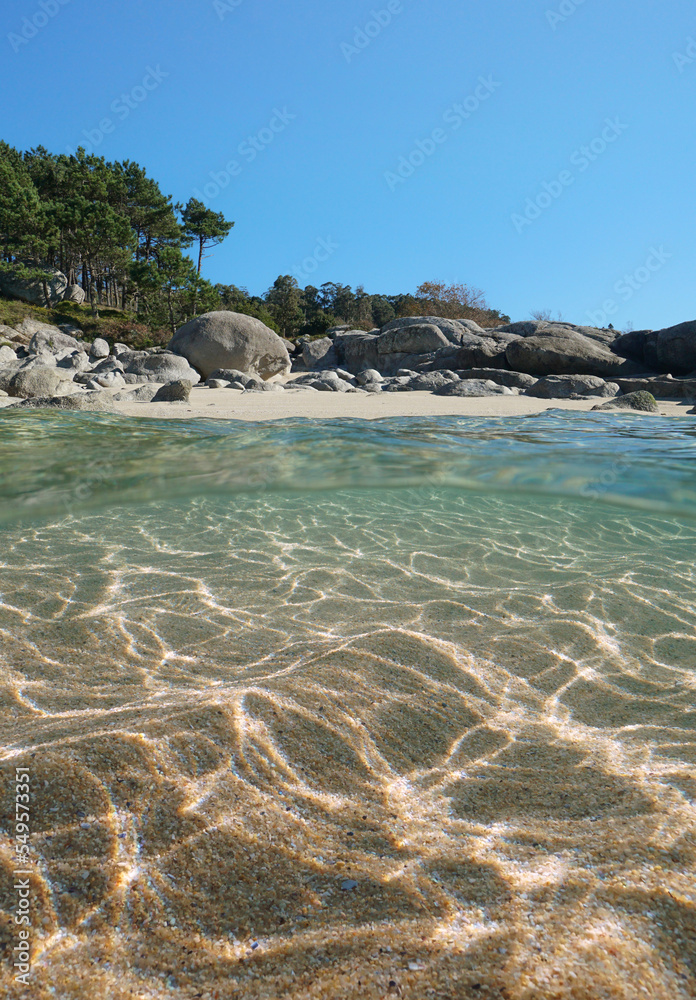 Beach with rocks and sand underwater, sea shore over and under water ...