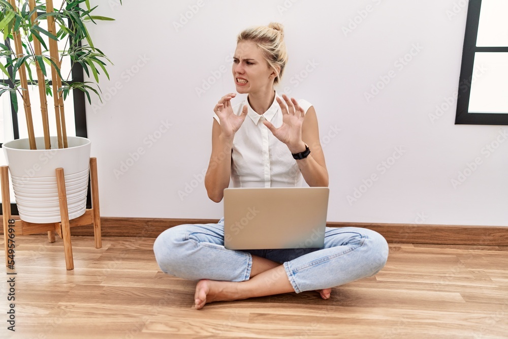 Poster Young blonde woman using computer laptop sitting on the floor at ...