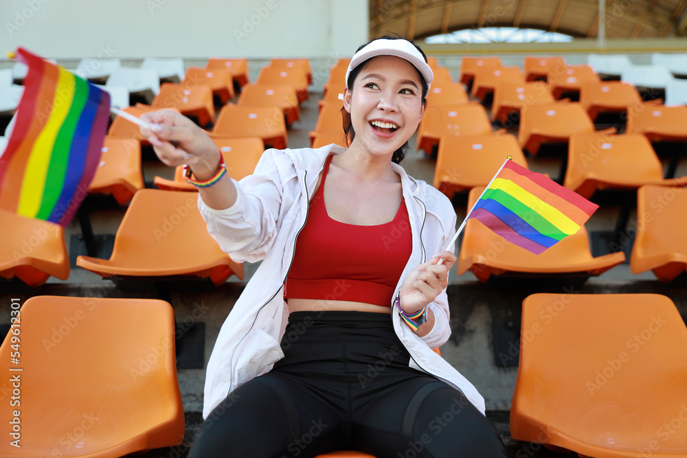 Happy and excited young female asian transgender LGBT sport fan ...