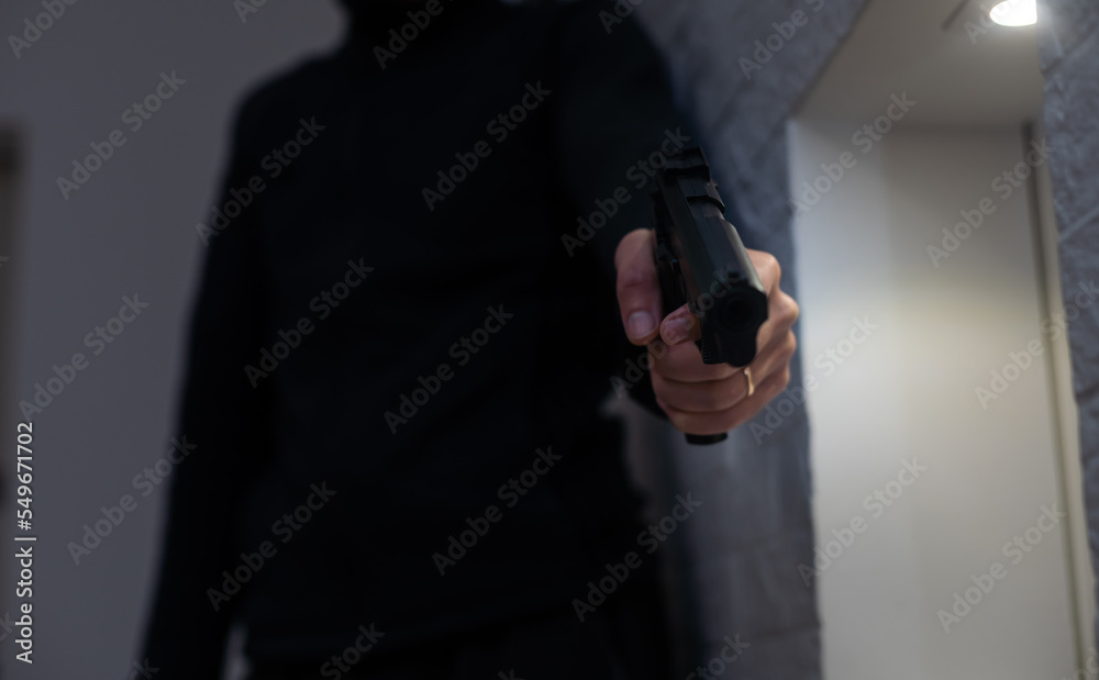 Threat of firearms. Muzzle of gun in man's hand is pointed at camera ...