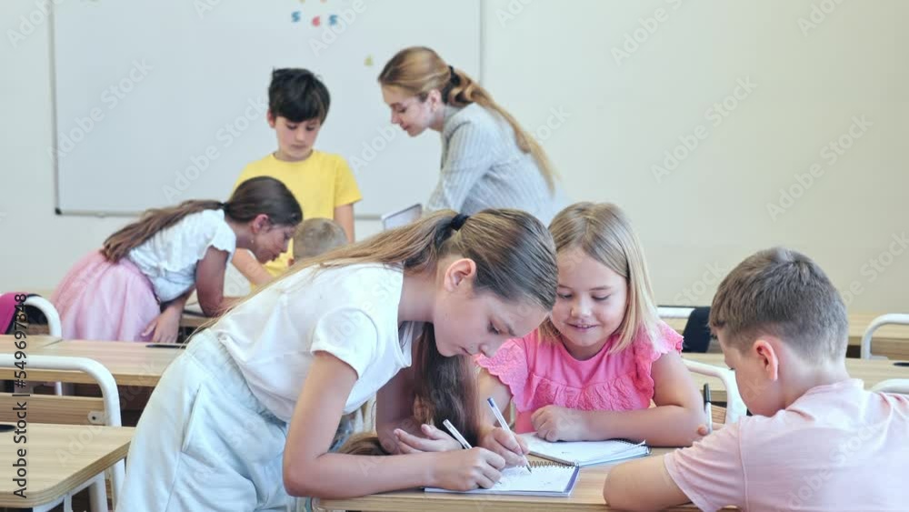 Interested preteen pupils divided into small groups, discussing ...