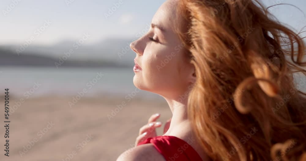 Red-Haired Girl Enjoys the Sun and Fresh Wind Standing on the Shore ...