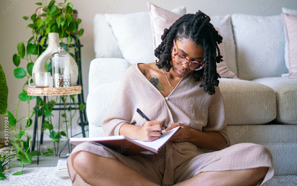 Young woman journaling in her home Stock Photo | Adobe Stock