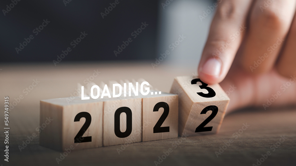 Start change year loading 2022 to 2023 , Businessman flipping wooden ...