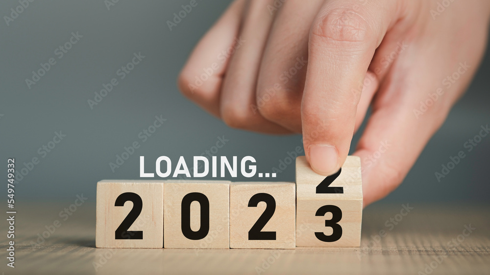 Start change year loading 2022 to 2023 , Businessman flipping wooden cube block to change 2022 ...