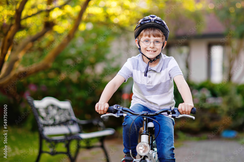Happy school kid boy having fun with riding of bicycle. Active child ...