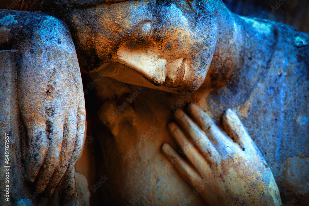 Ancient stone statue of sad and desperate woman on tomb as a symbol of ...