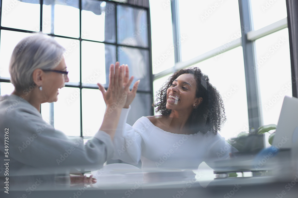 Female colleagues of different nationalities and ages met in the office ...