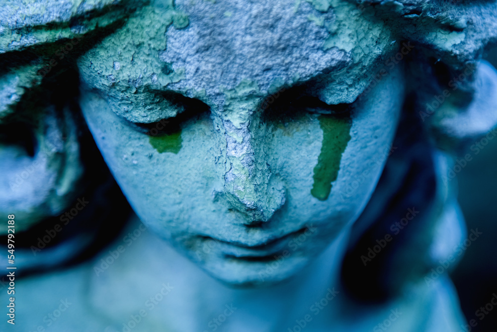 Crying angel as symbol of pain, fear and end of human life. Fragment of ...