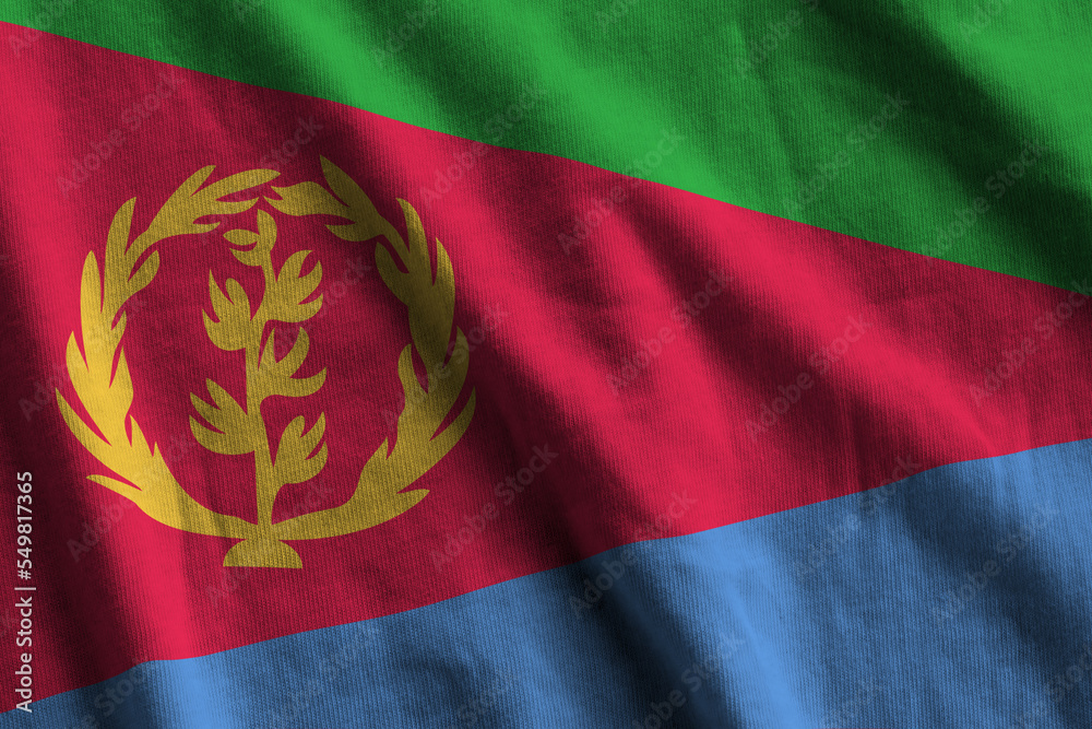 Eritrea flag with big folds waving close up under the studio light ...