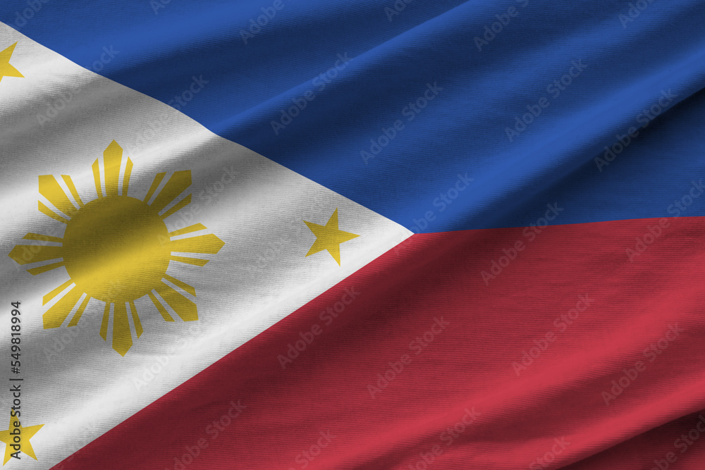 Philippines flag with big folds waving close up under the studio light ...
