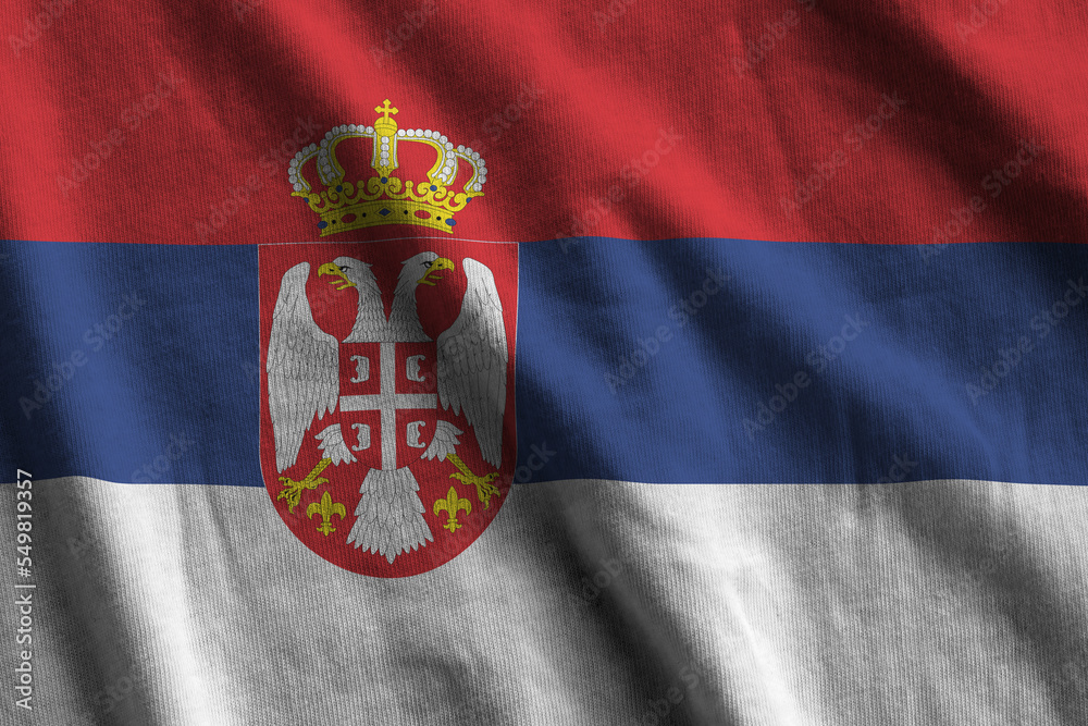 Serbia flag with big folds waving close up under the studio light ...