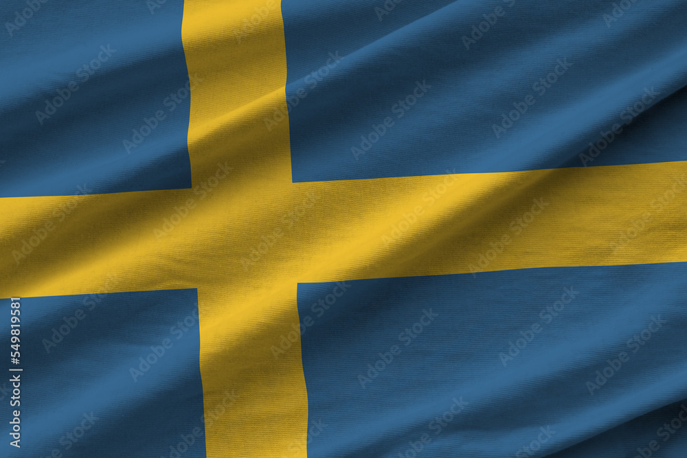Sweden flag with big folds waving close up under the studio light ...