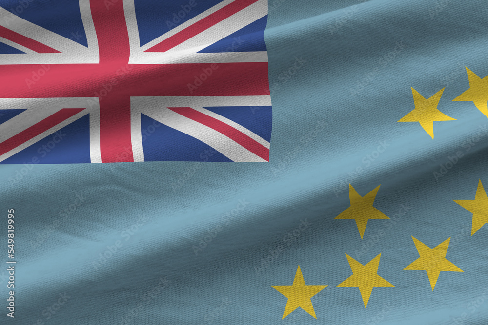 Tuvalu flag with big folds waving close up under the studio light ...