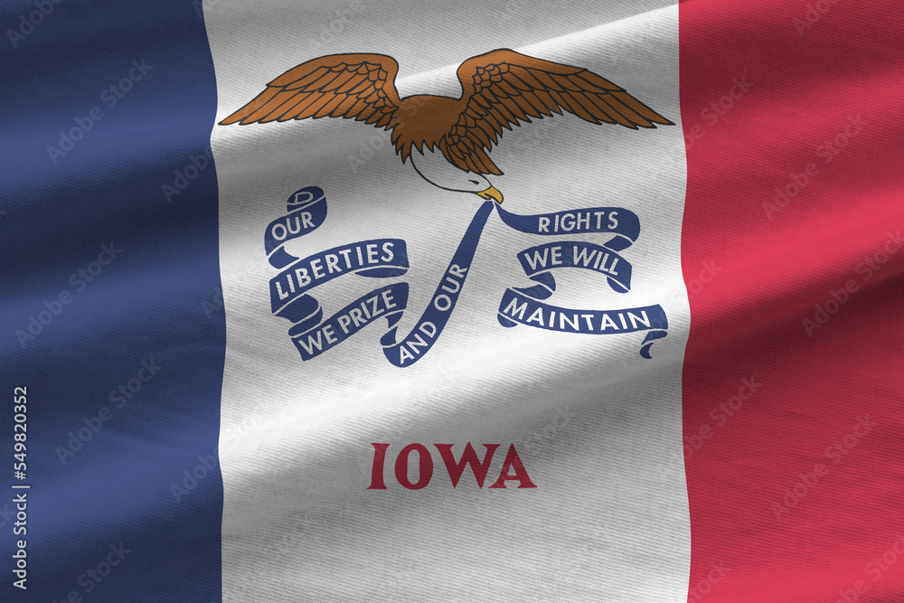 Iowa US state flag with big folds waving close up under the studio ...
