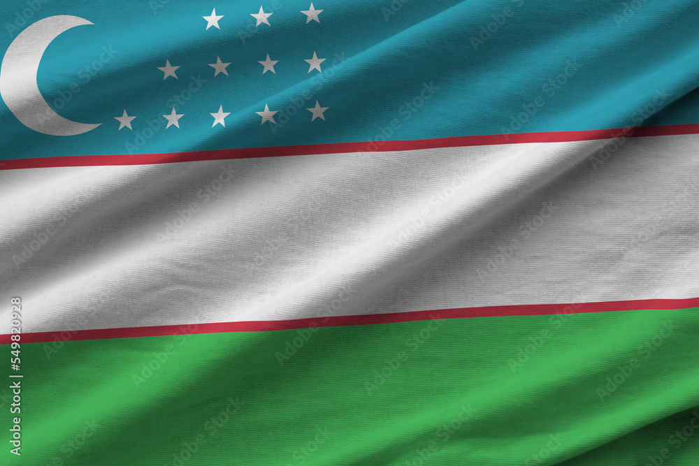Uzbekistan flag with big folds waving close up under the studio light ...