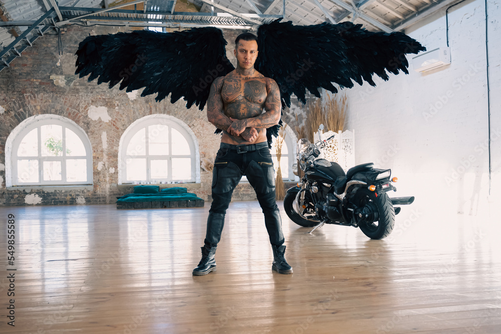 angel man with black wings, stand posing at camera. man fall from ...