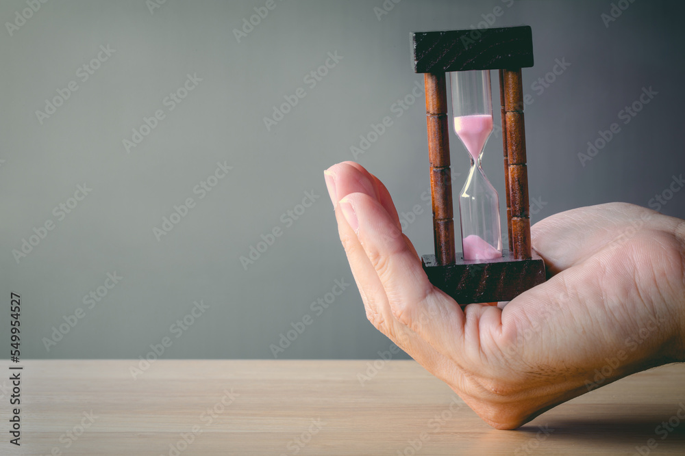 Concept image of management at the time of life. Abstract hourglass on ...