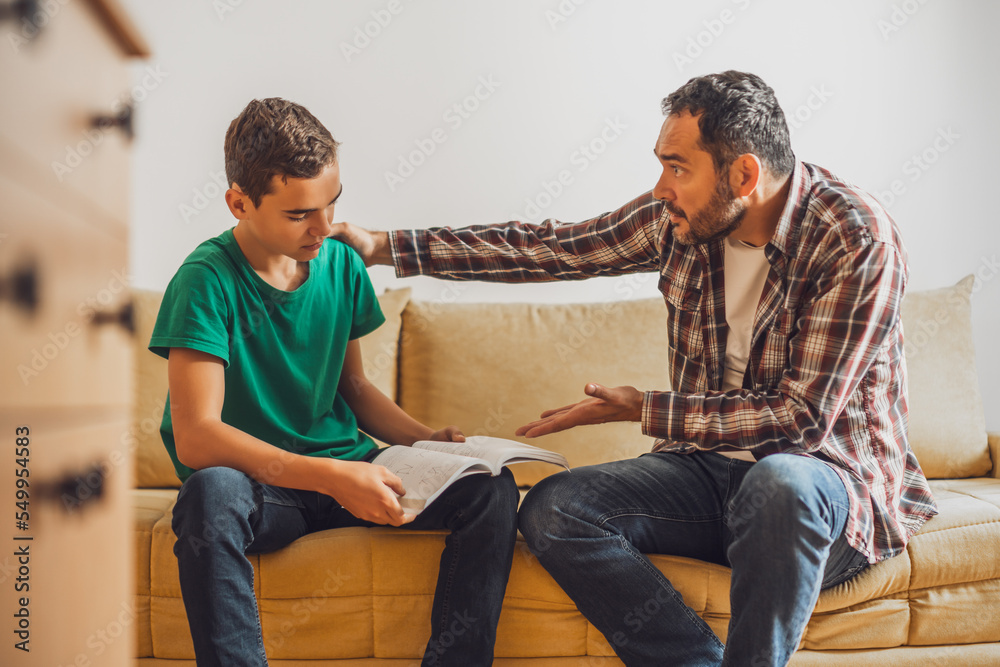 Father is helping his son with learning. Boy is having problem with ...