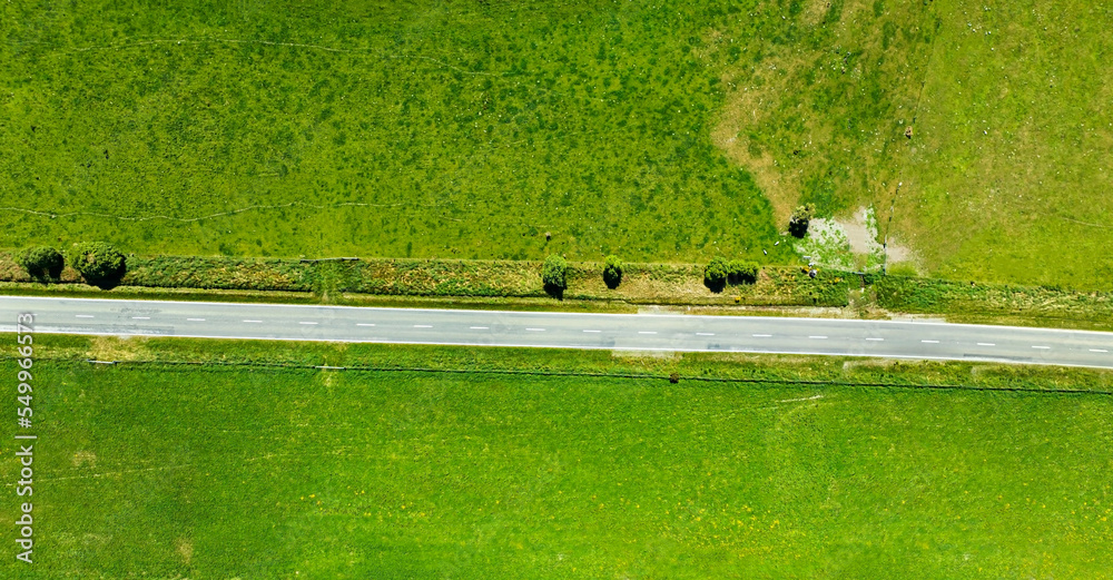 Aerial top view with road trough the empty asphalt road at the green ...