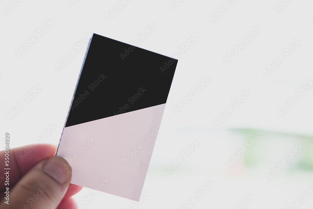 A hand holding a paper movie ticket. Blank template of ticket that you ...