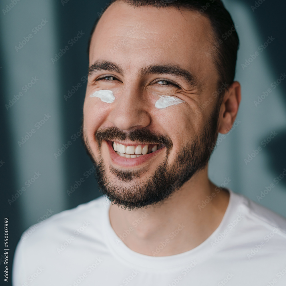 Portrait of a cheerful male looking at camera with smile and having ...