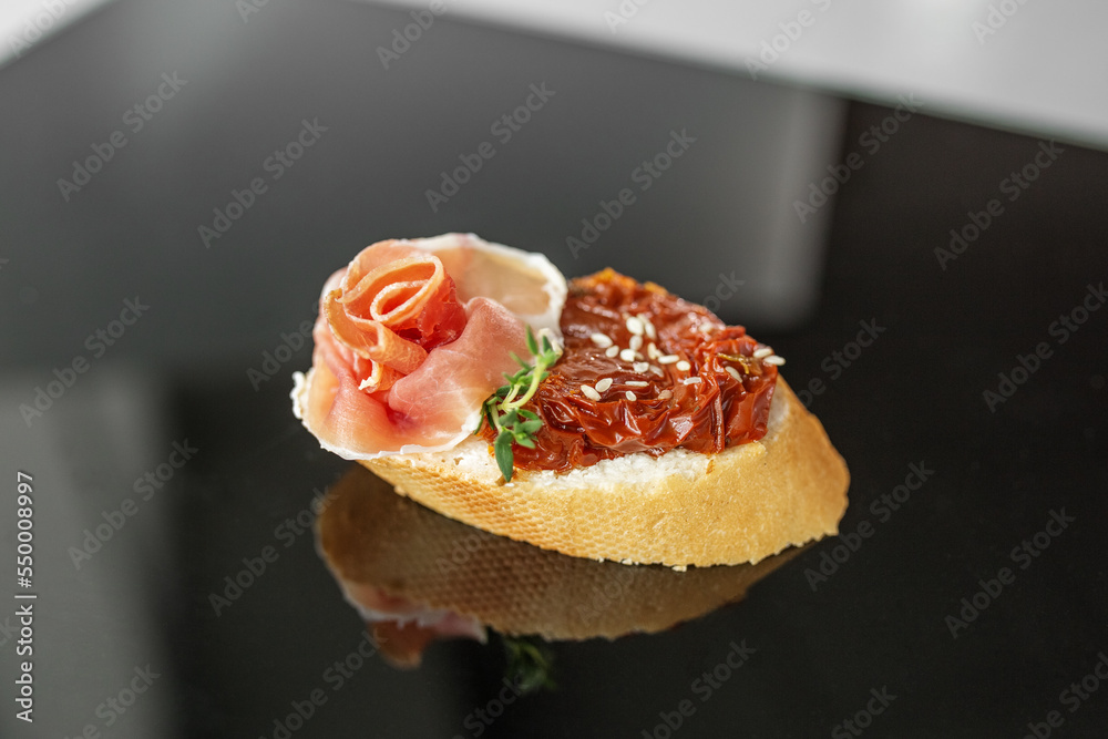 Appetizer with prosciutto, bruschetta and sun-dried tomato. Food ...