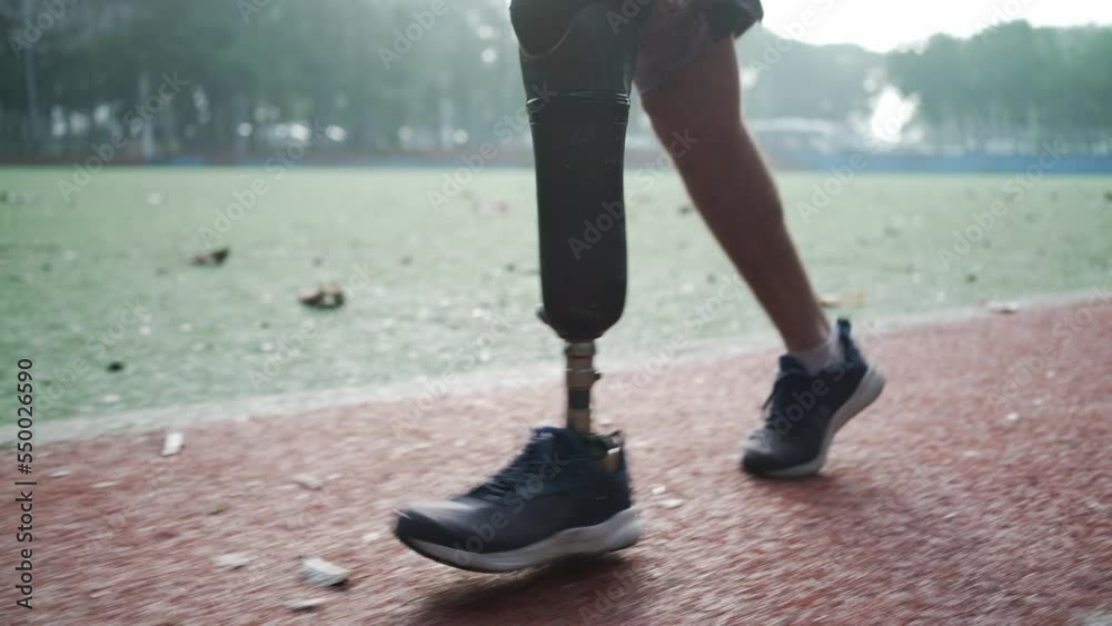 Amputee athlete running with prosthetic leg. Disabled runner with ...