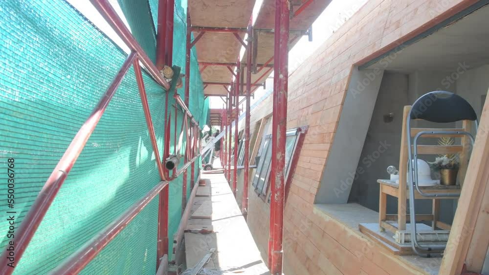 Scaffolding around the building. POV from above scaffolding ...