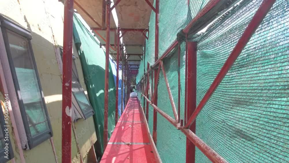 Scaffolding around the building. POV from above scaffolding ...