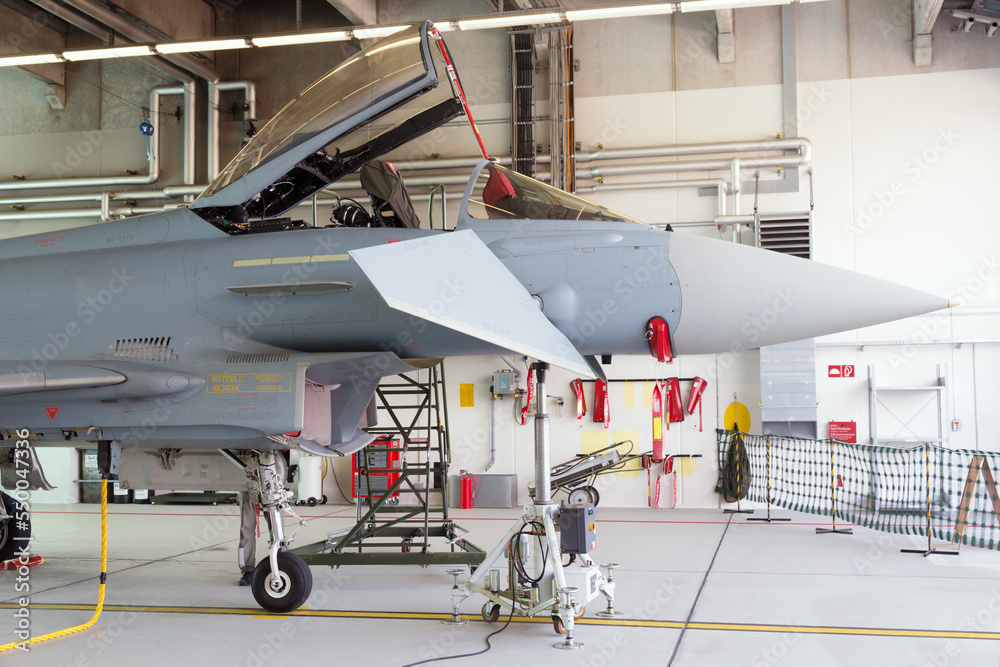 European modern military air force fighter jet in a hangar on an air ...
