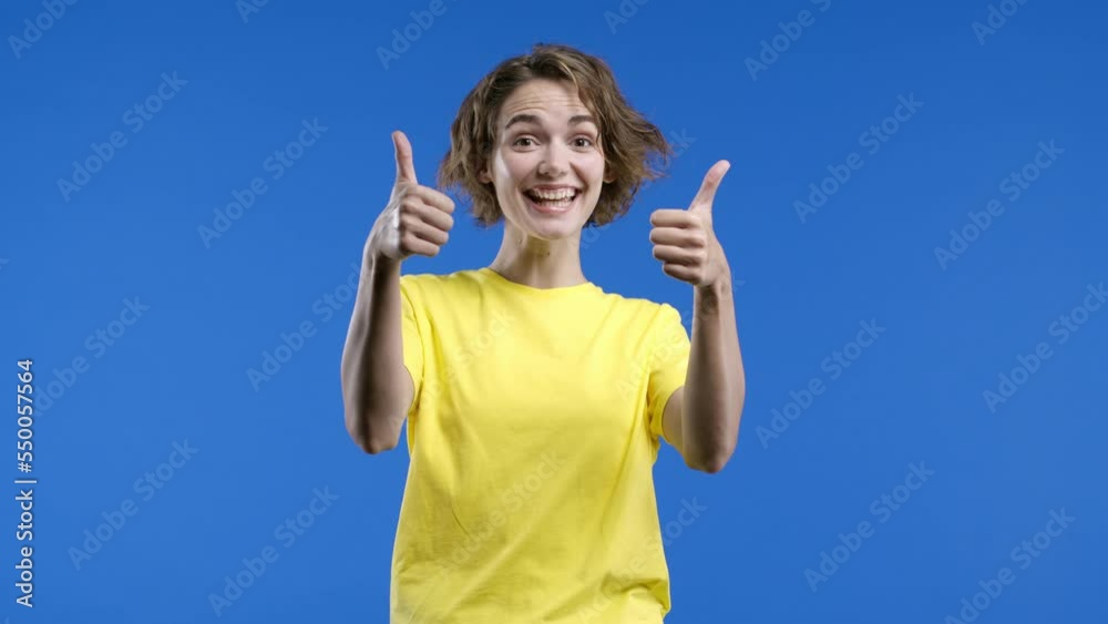 Pretty woman makes hand sign like, thumbs up gesture. Happy girl ...