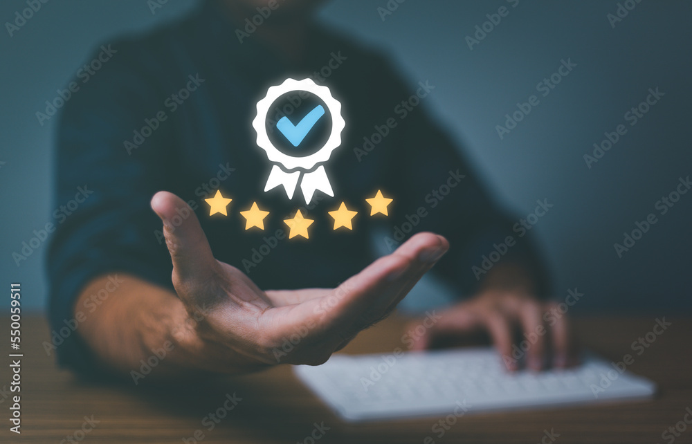 Businessman holding and showing the best quality assurance with golden ...