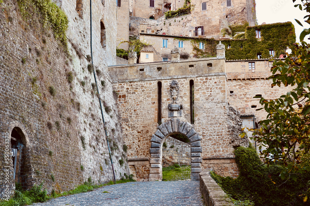 The ancient city gate Porta dei Merli at the entrance to the old town ...